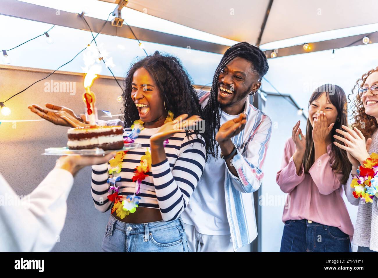 Multiracial young group of friends at terrace together celebrating with ...