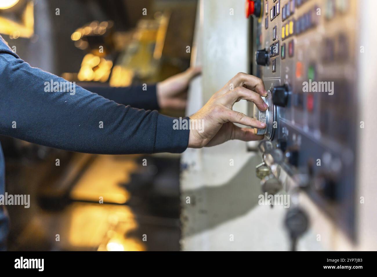 Side view of the hands of a male caucasian worker using control panel ...