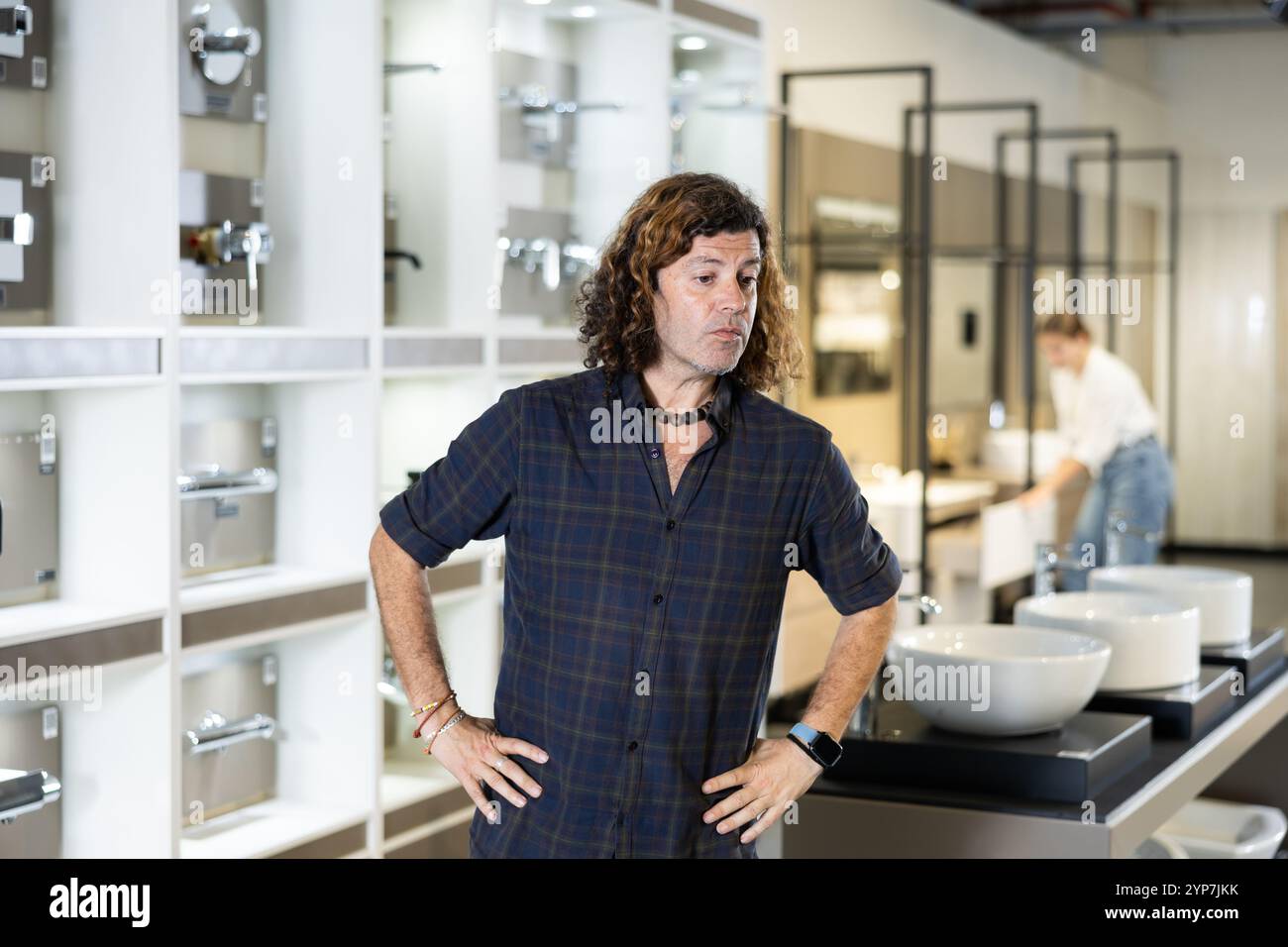 Confident male customer looking around in bathroom section of hardware ...