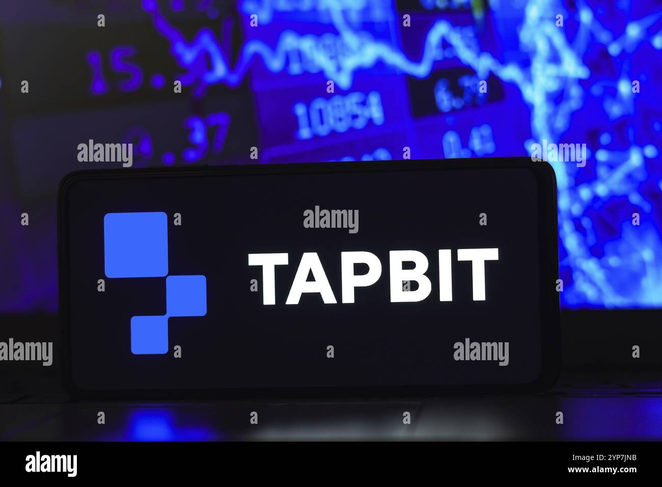 In this photo illustration, the Tapbit logo seen displayed on a ...