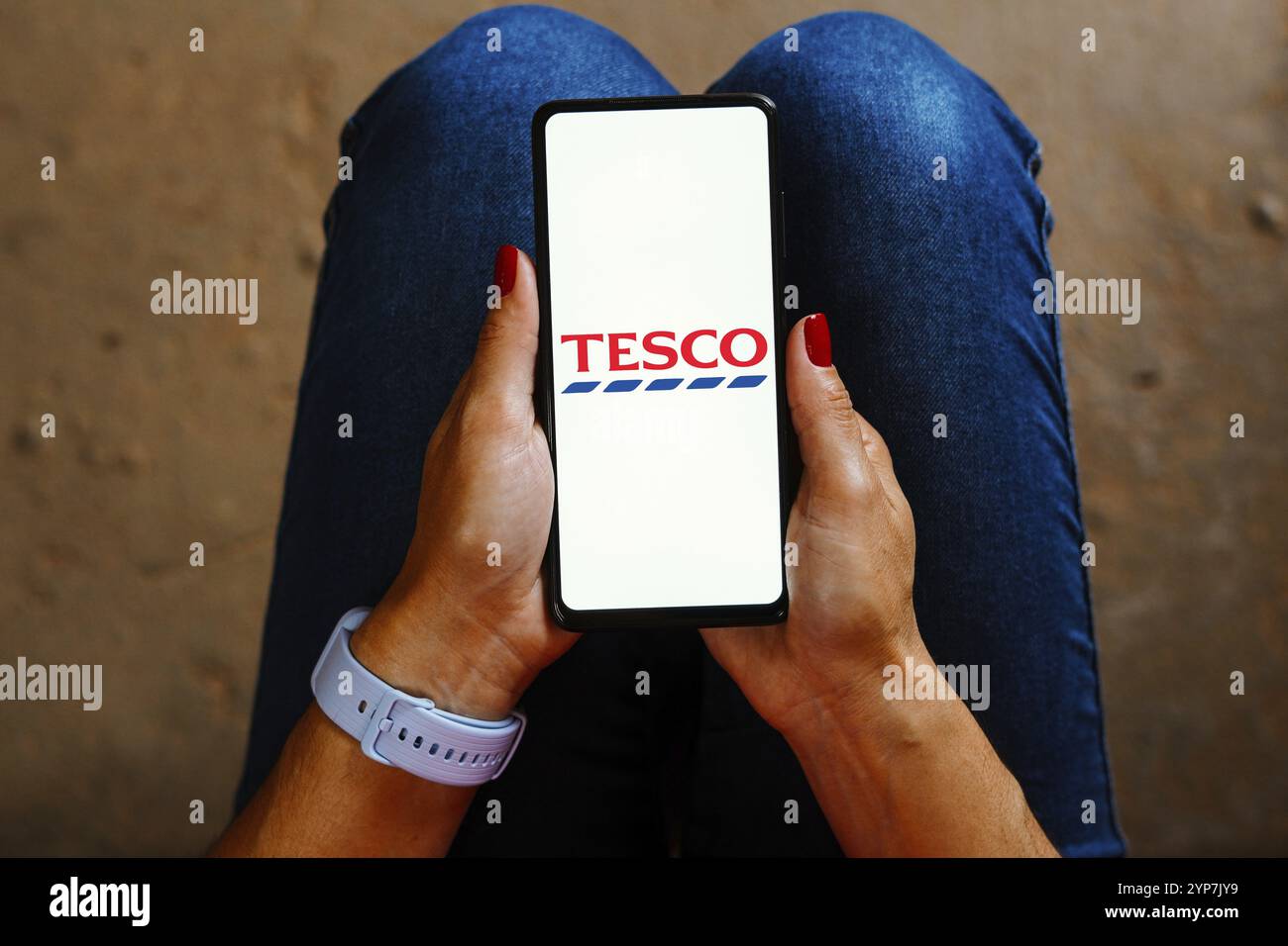 In this photo illustration, the Tesco logo is displayed on a smartphone ...