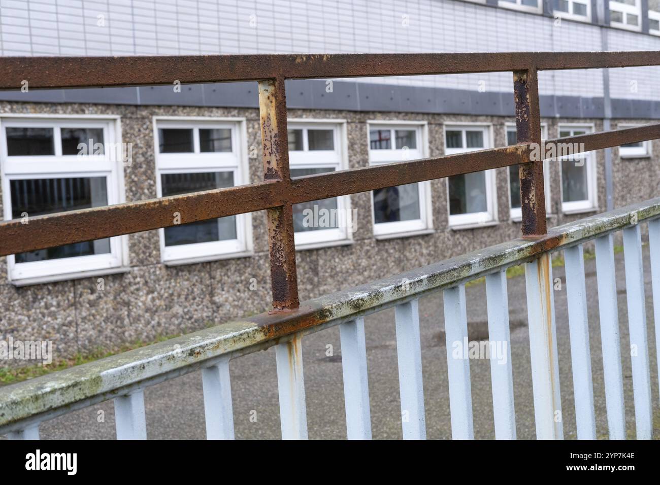 Rusty railing in front of old office building Stock Photo - Alamy