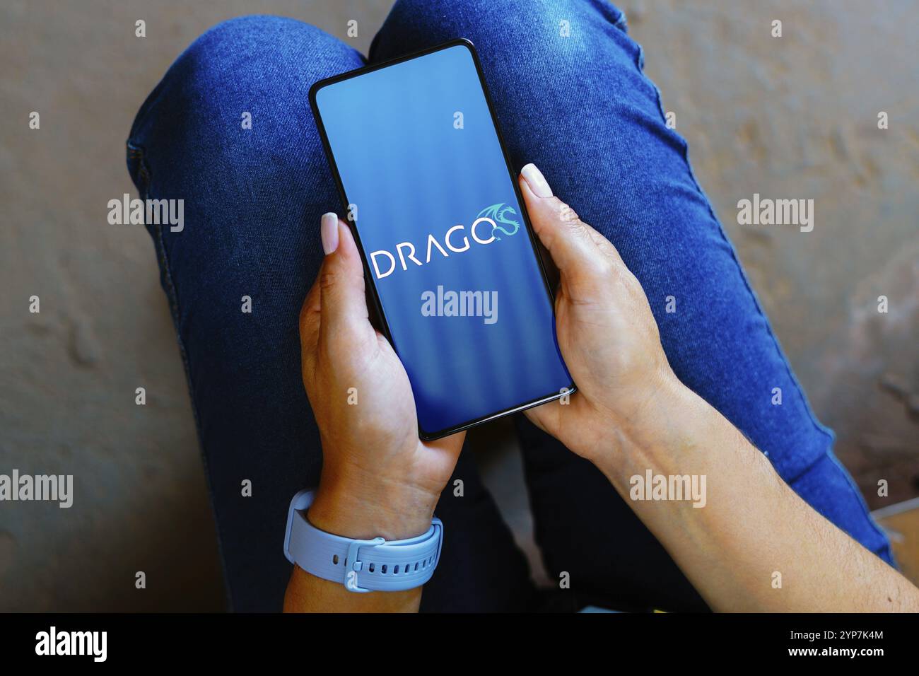 In this photo illustration, the Dragos logo is displayed on a ...