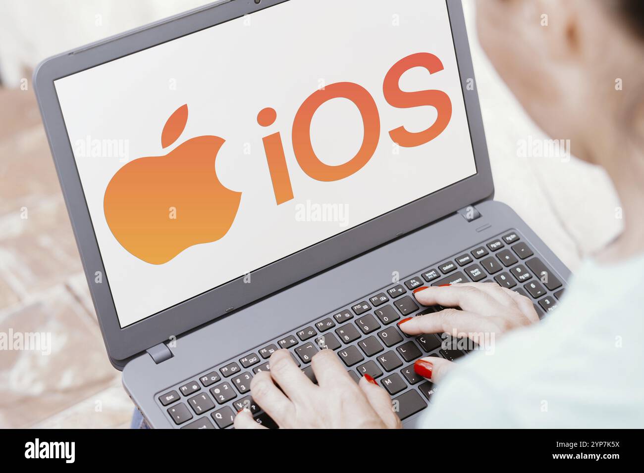 In this photo illustration, the Apple iOS logo is displayed on a laptop screen Stock Photo - Alamy