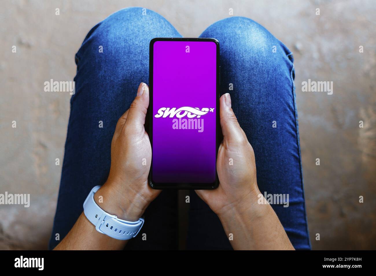 In this photo illustration, the Swoop logo is displayed on a smartphone screen Stock Photo - Alamy