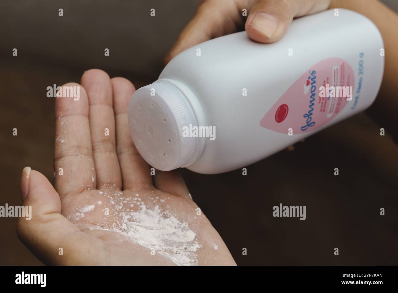 In this photo illustration, a person uses Johnson Johnson baby powder ...