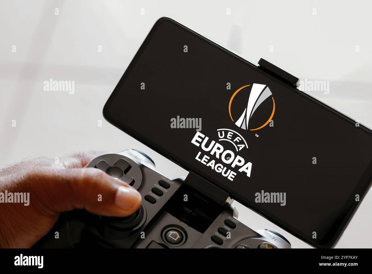 In this photo illustration, a person plays on a gaming joystick and the ...