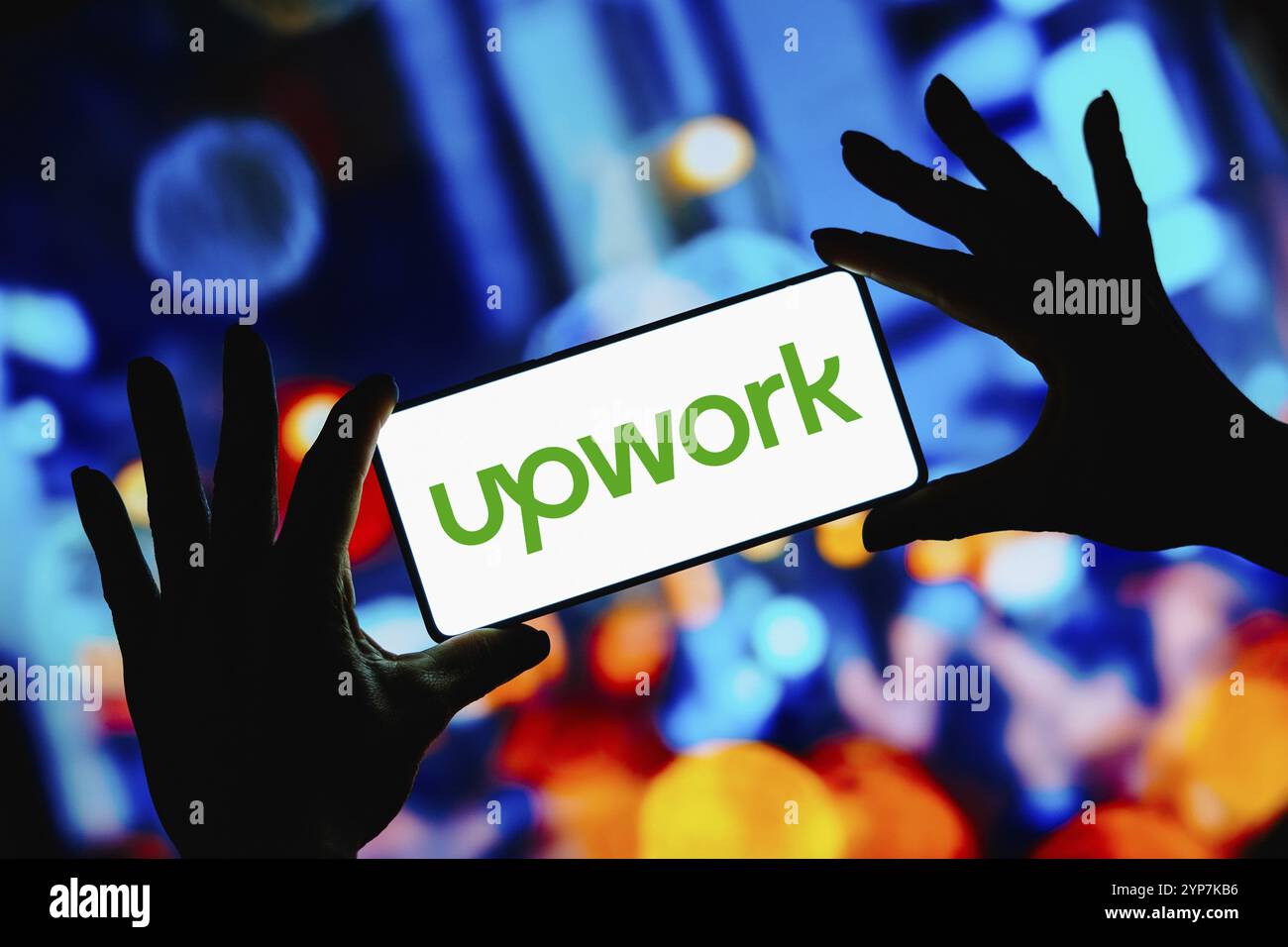 In this photo illustration, the Upwork logo is displayed on a smartphone screen Stock Photo - Alamy