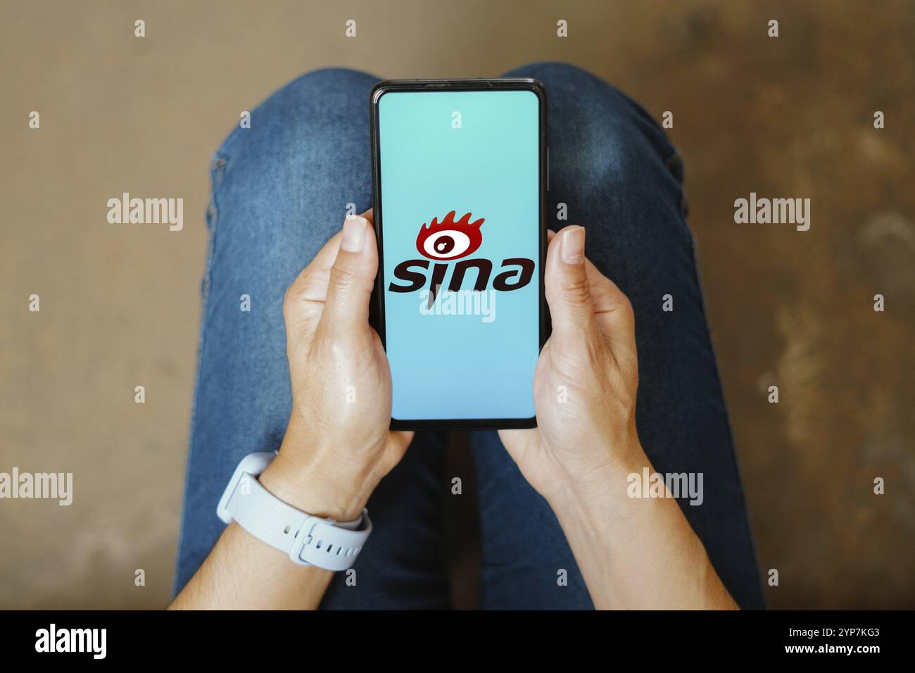 In this photo illustration, the Sina Corporation logo seen displayed on a smartphone Stock Photo ...