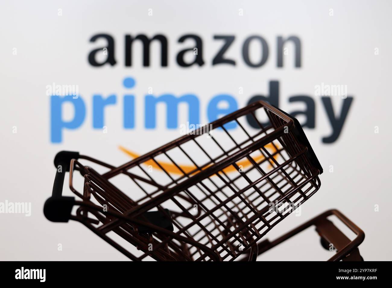 In this photo illustration, a shopping cart is seen in front of the Amazon Prime Day logo Stock ...