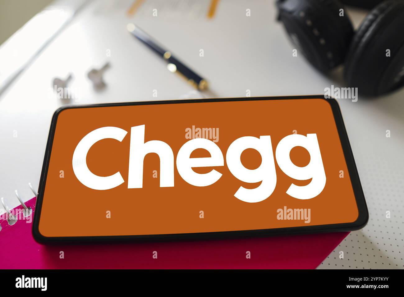 In this photo illustration, the Chegg logo is displayed on a smartphone ...