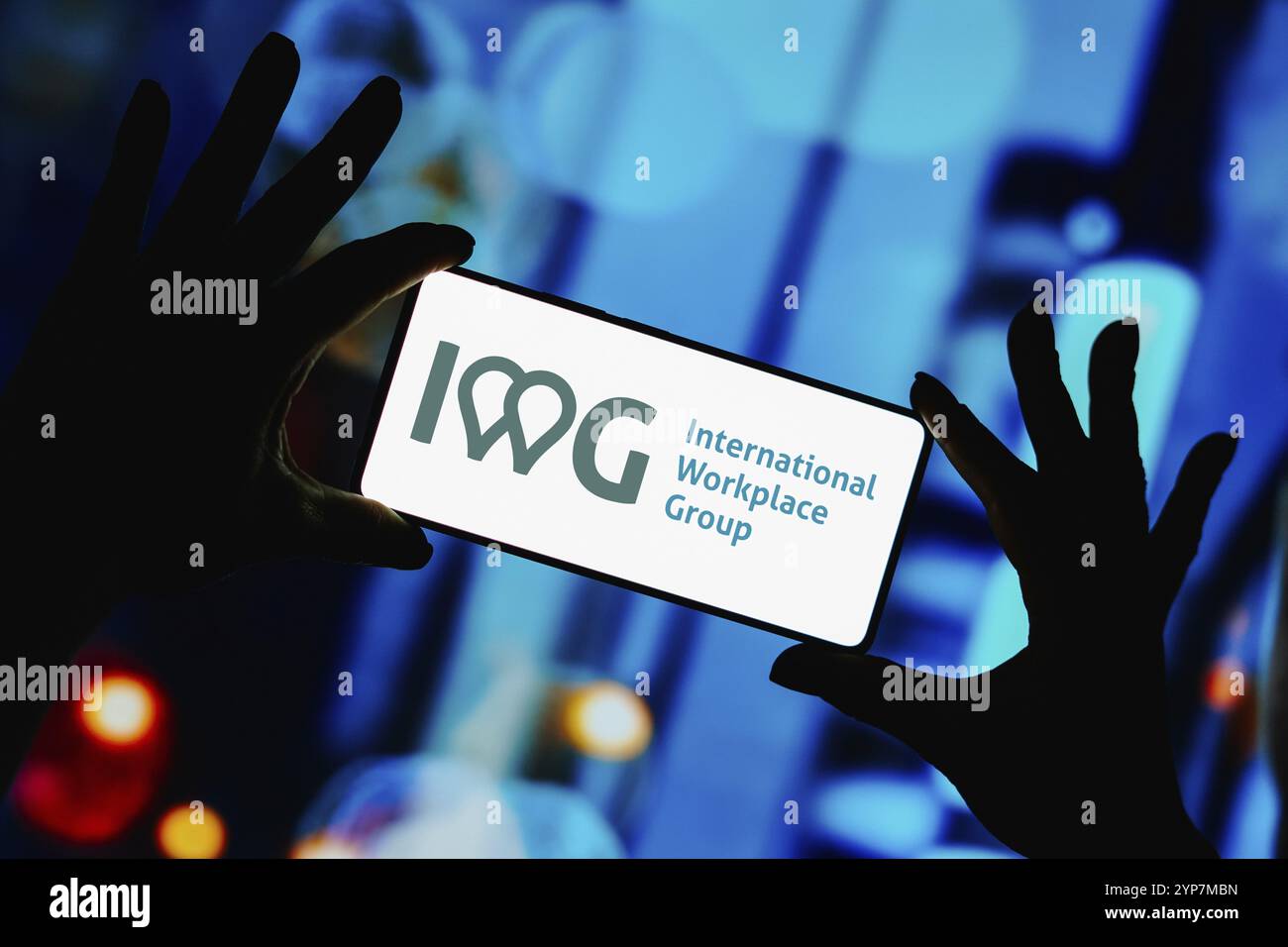In this photo illustration, the International Workplace Group (IWG) logo is displayed on a ...