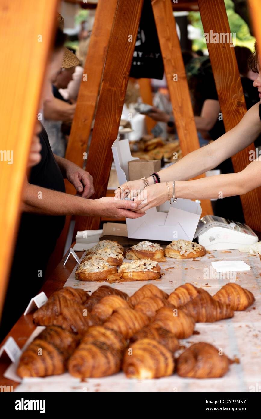 choosing and buying fresh bread and pastries at farmers food market ...