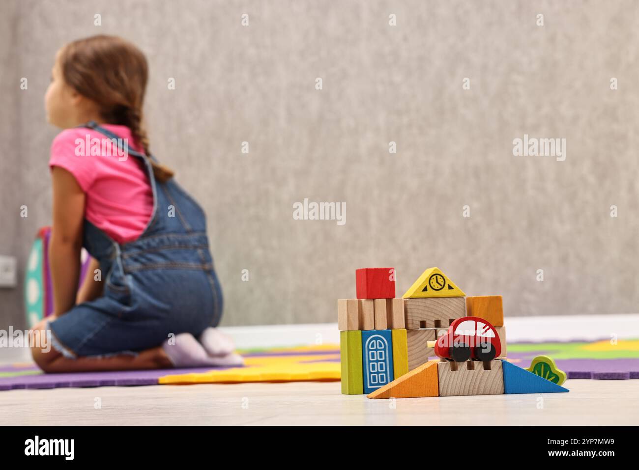 Autism therapy. Little girl sitting on floor in mental health center ...