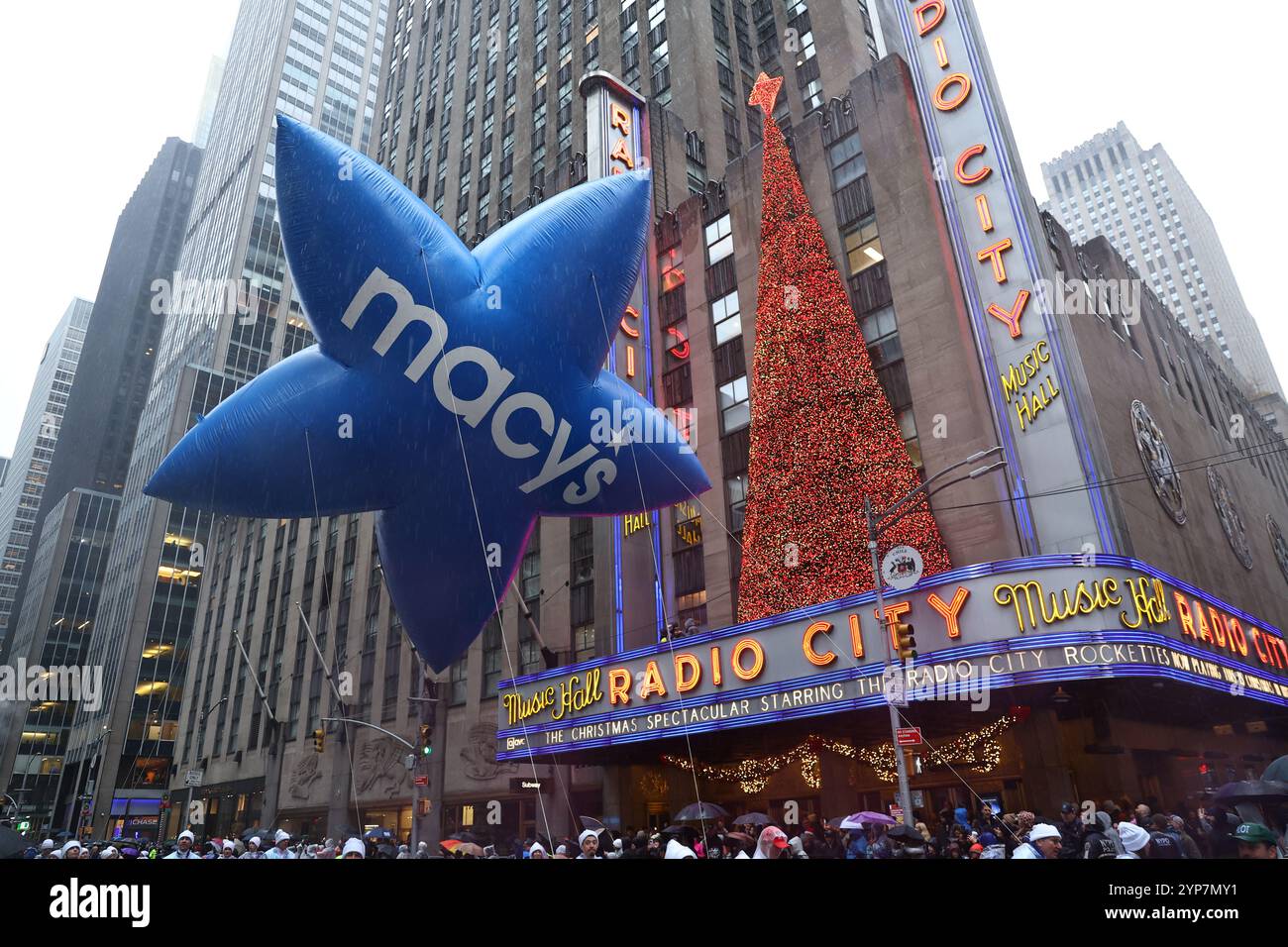 The Macy's Blue Star heads down Central Park West during The 98th Macy ...