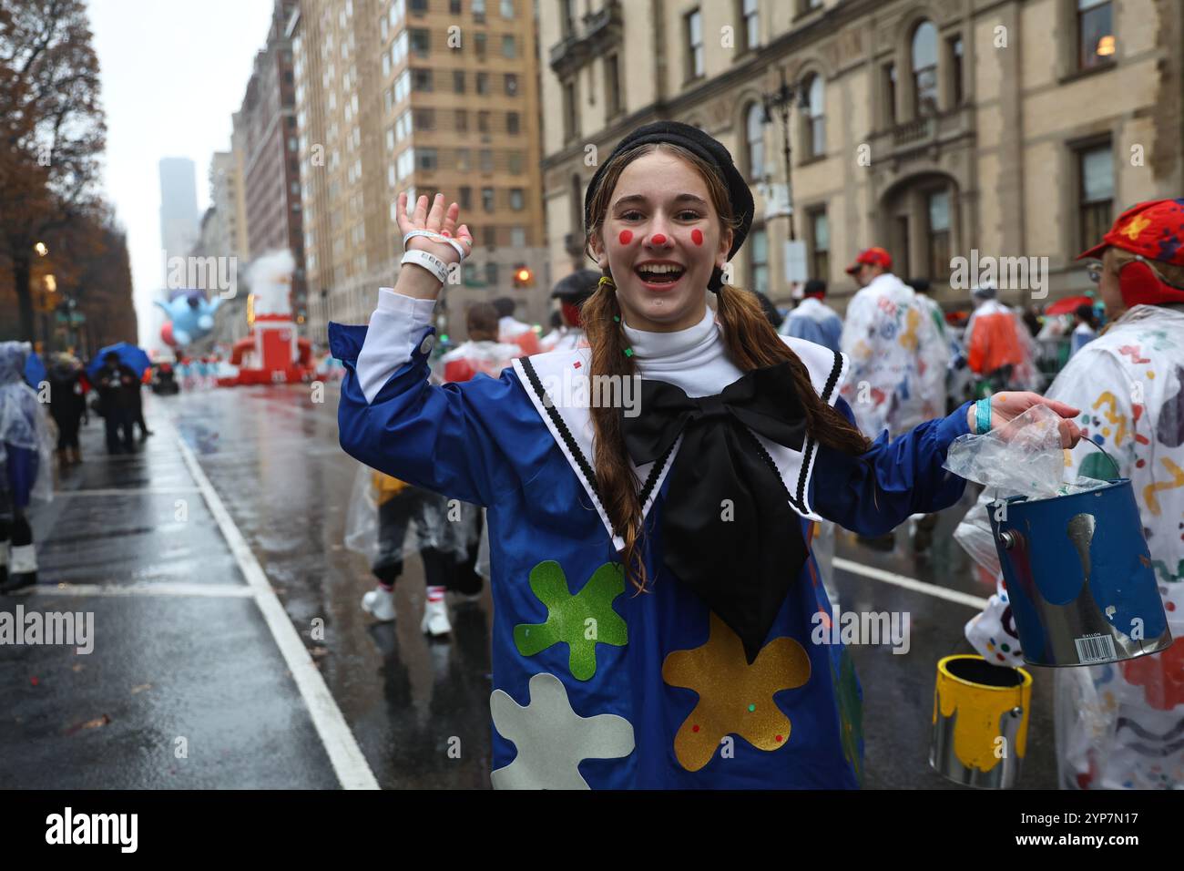 A member of the Artist Clowns hits the photographer with confetti ...