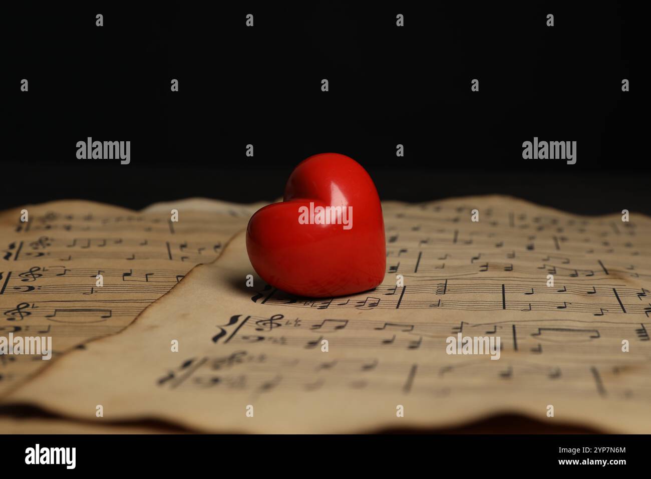 Heart figure and musical notes on black background, closeup Stock Photo ...