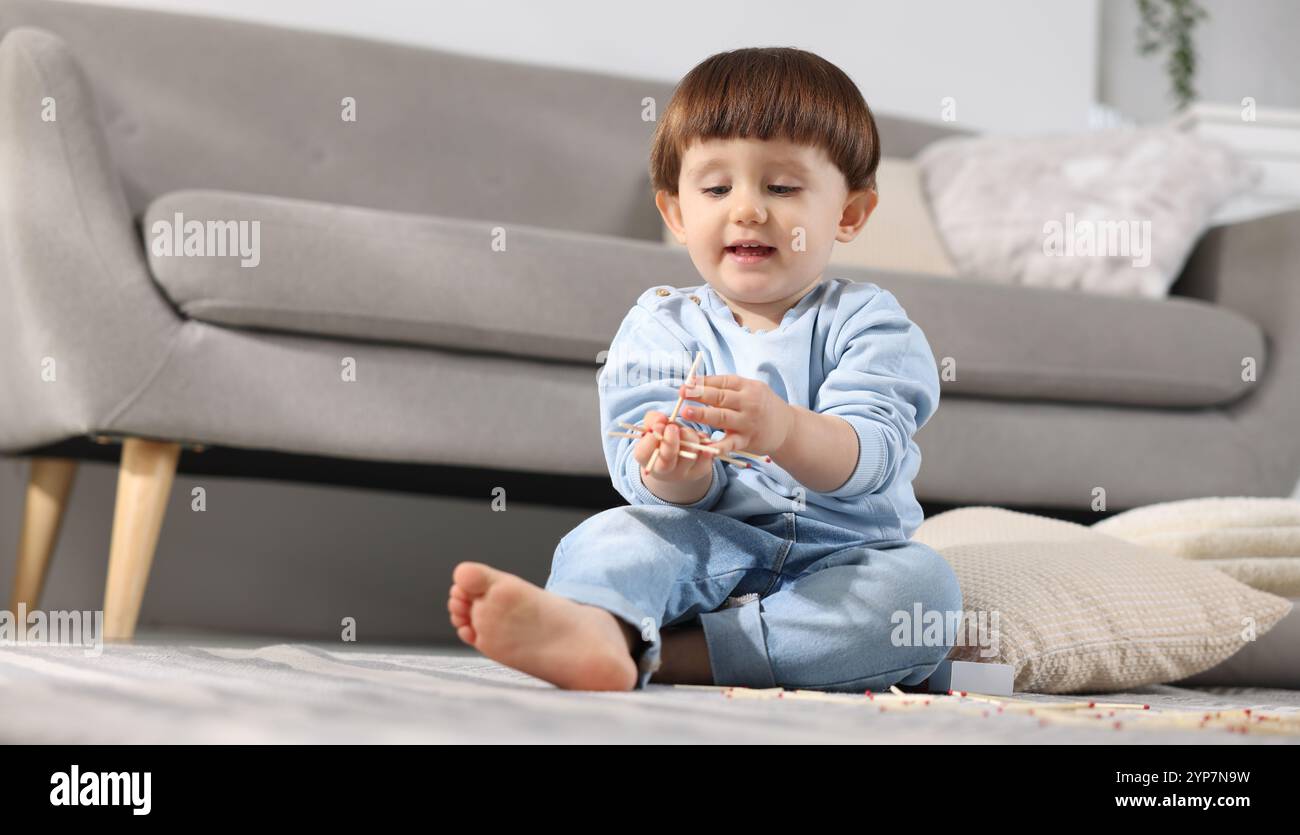 Little boy playing with matches at home. Child in danger Stock Photo ...