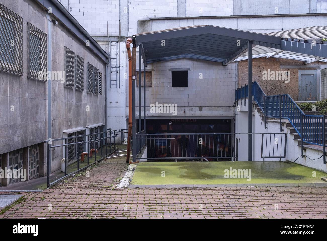 Gritty urban industrial area with metal stairs and concrete ...