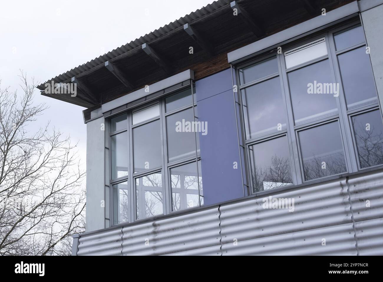 Contemporary building with large glass windows and corrugated metal ...