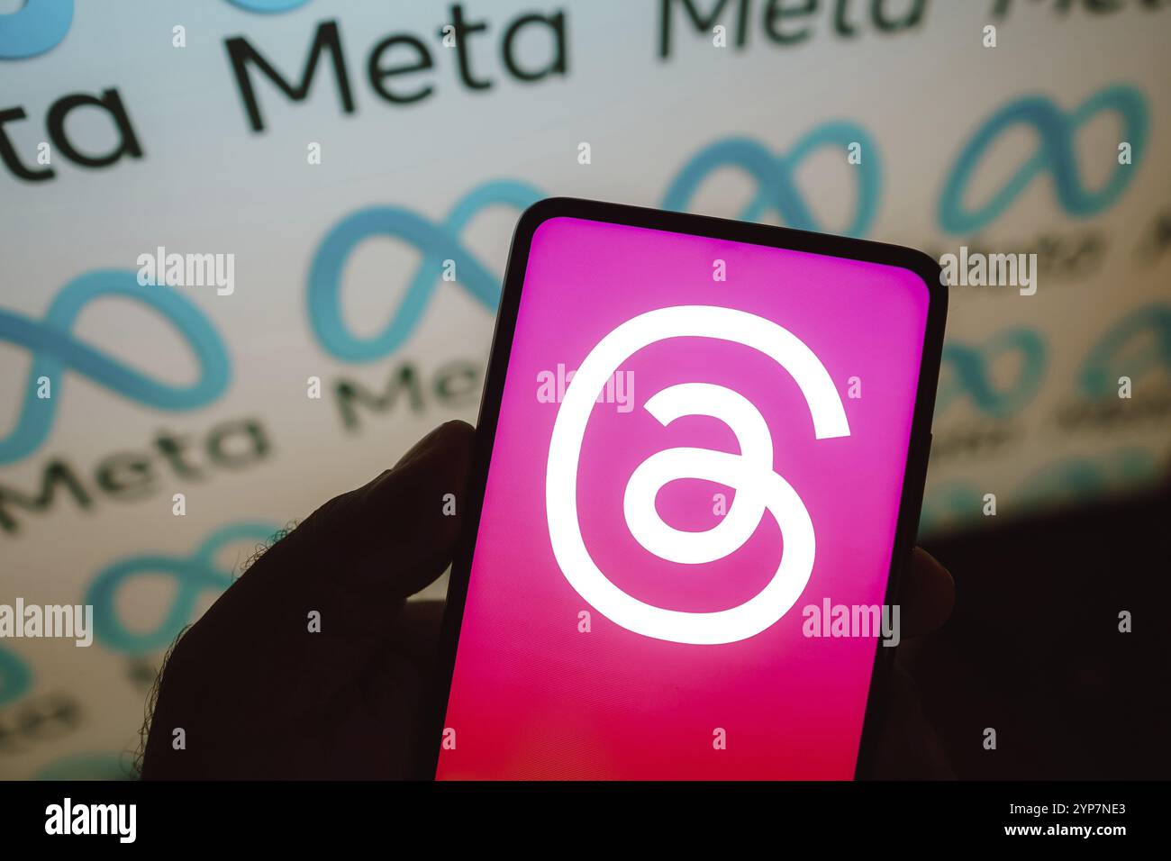 In this photo illustration, the Threads logo is displayed on a ...