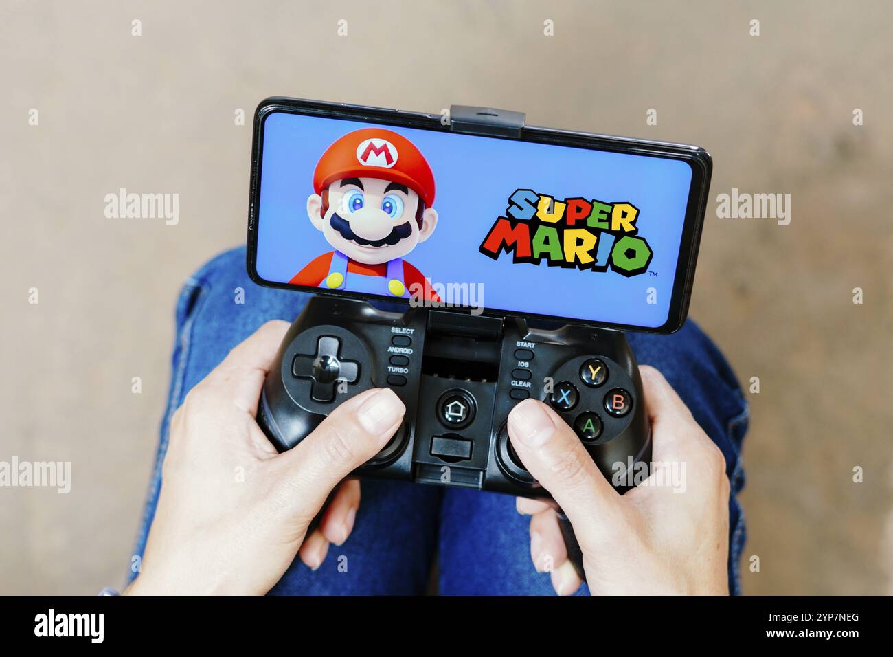 In this photo illustration, a person playing on a joystick and the ...
