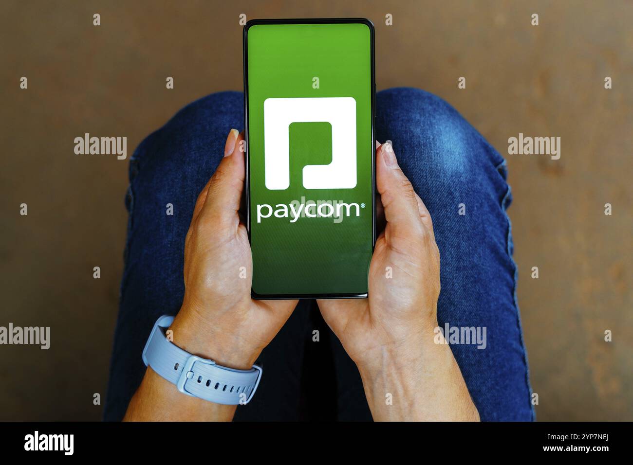 In this photo illustration, the Paycom logo is displayed on a ...