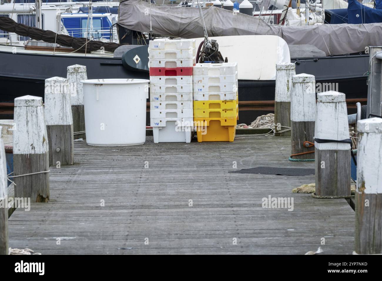 Fish boxes in the harbor at the jetty Stock Photo - Alamy