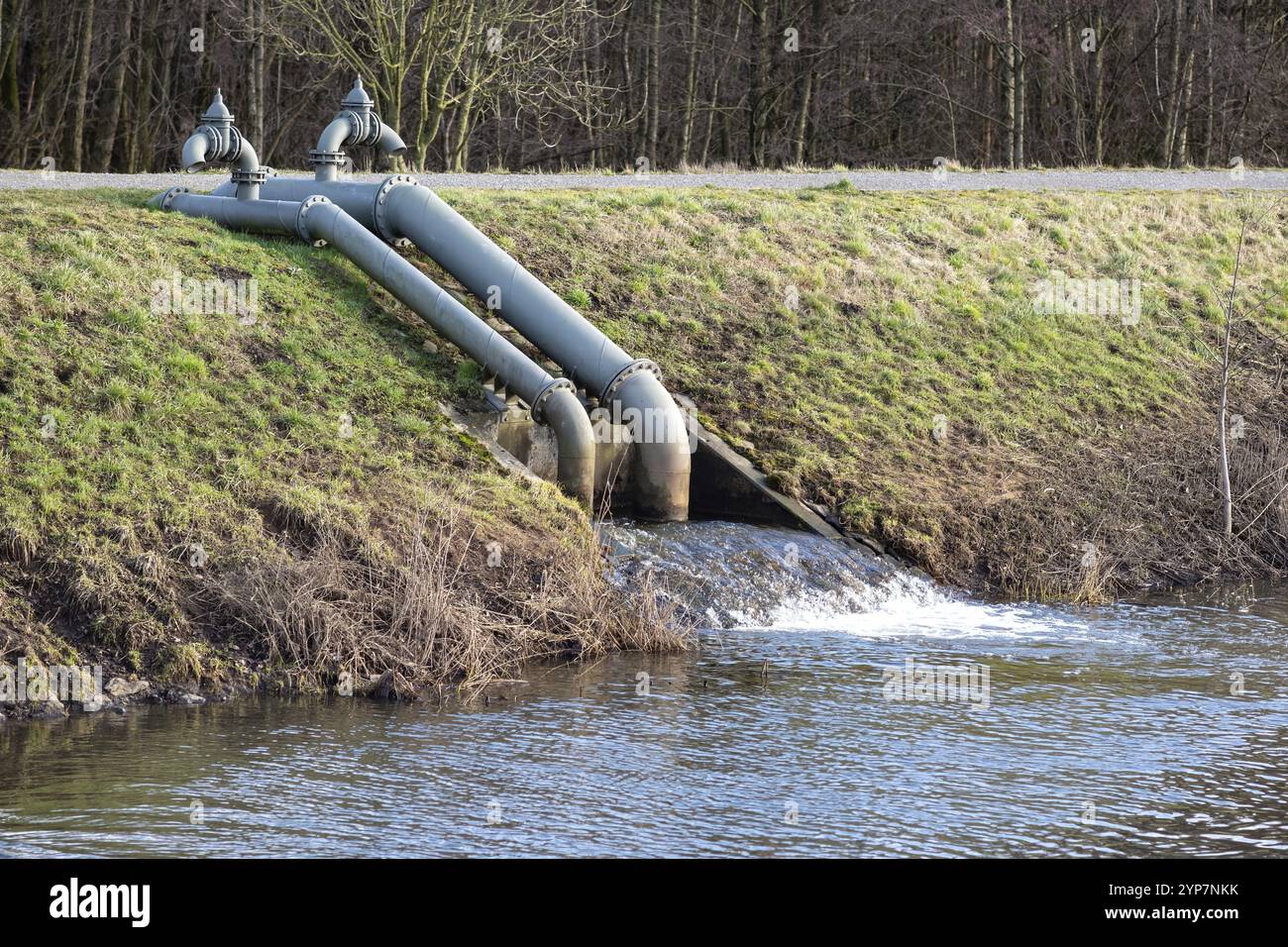 Pumping station on a river with dike Stock Photo - Alamy
