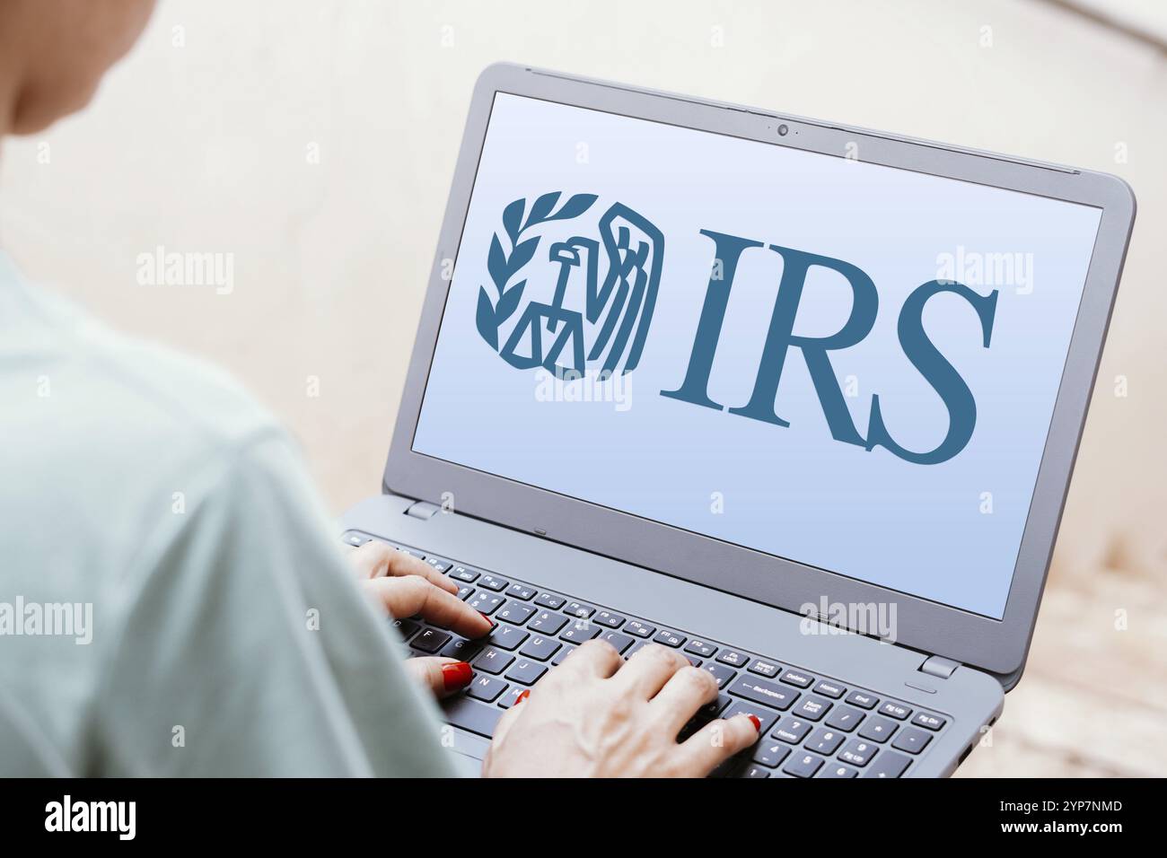 In this photo illustration, the Internal Revenue Service (IRS) logo is ...