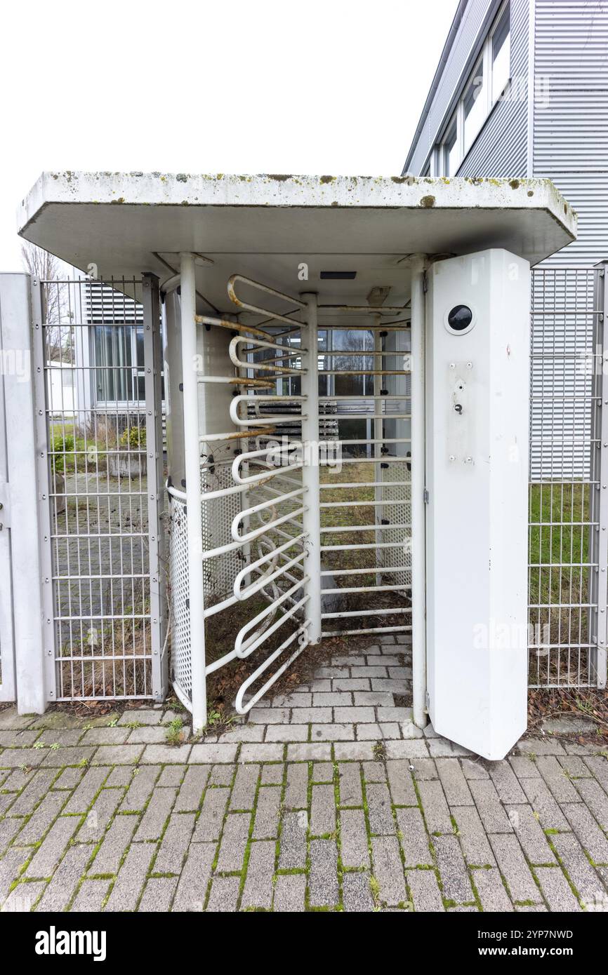 A turnstile gate with industrial design at an entrance, offering a ...