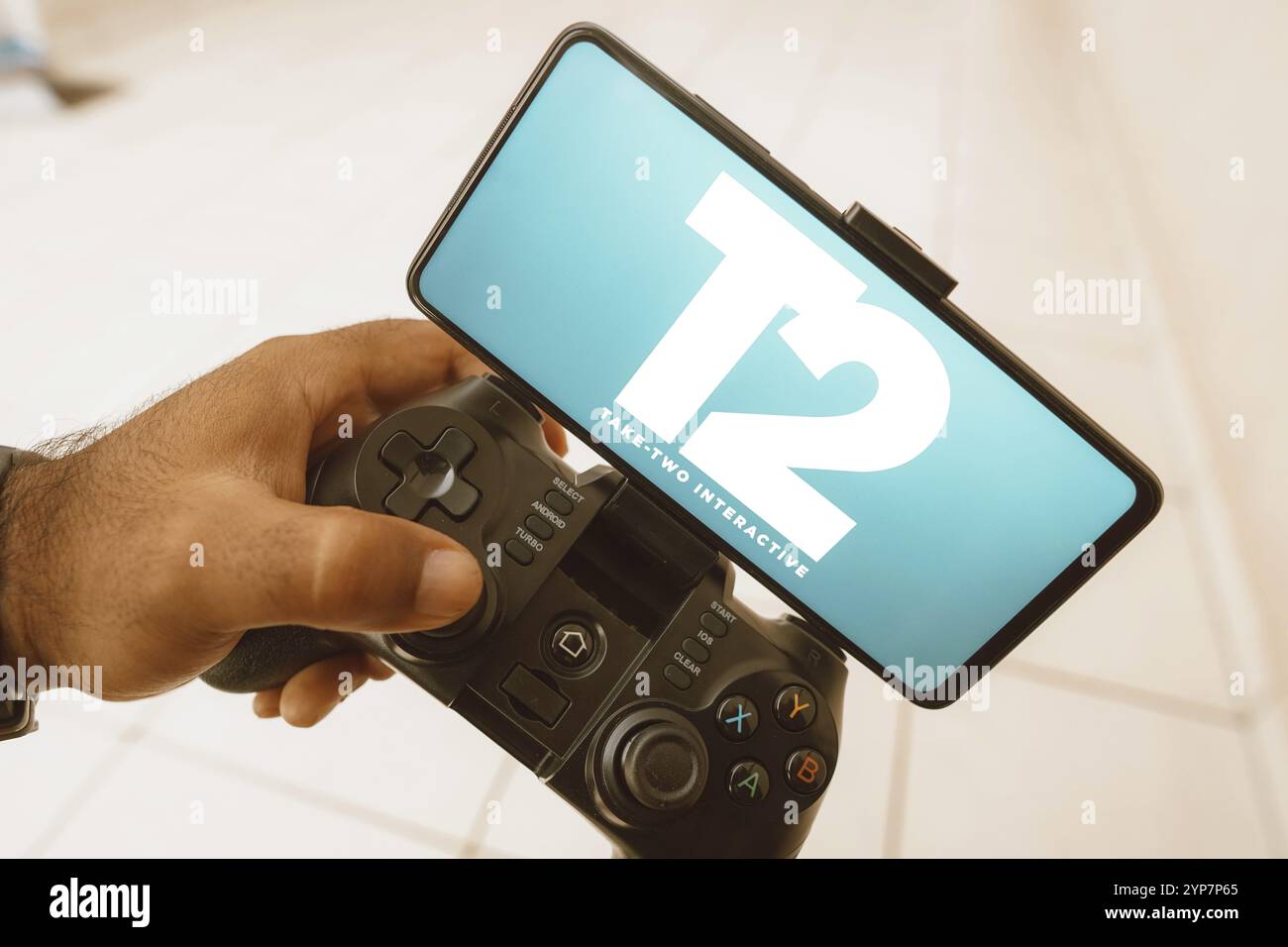 In this photo illustration, a person plays on a joystick and the Take ...