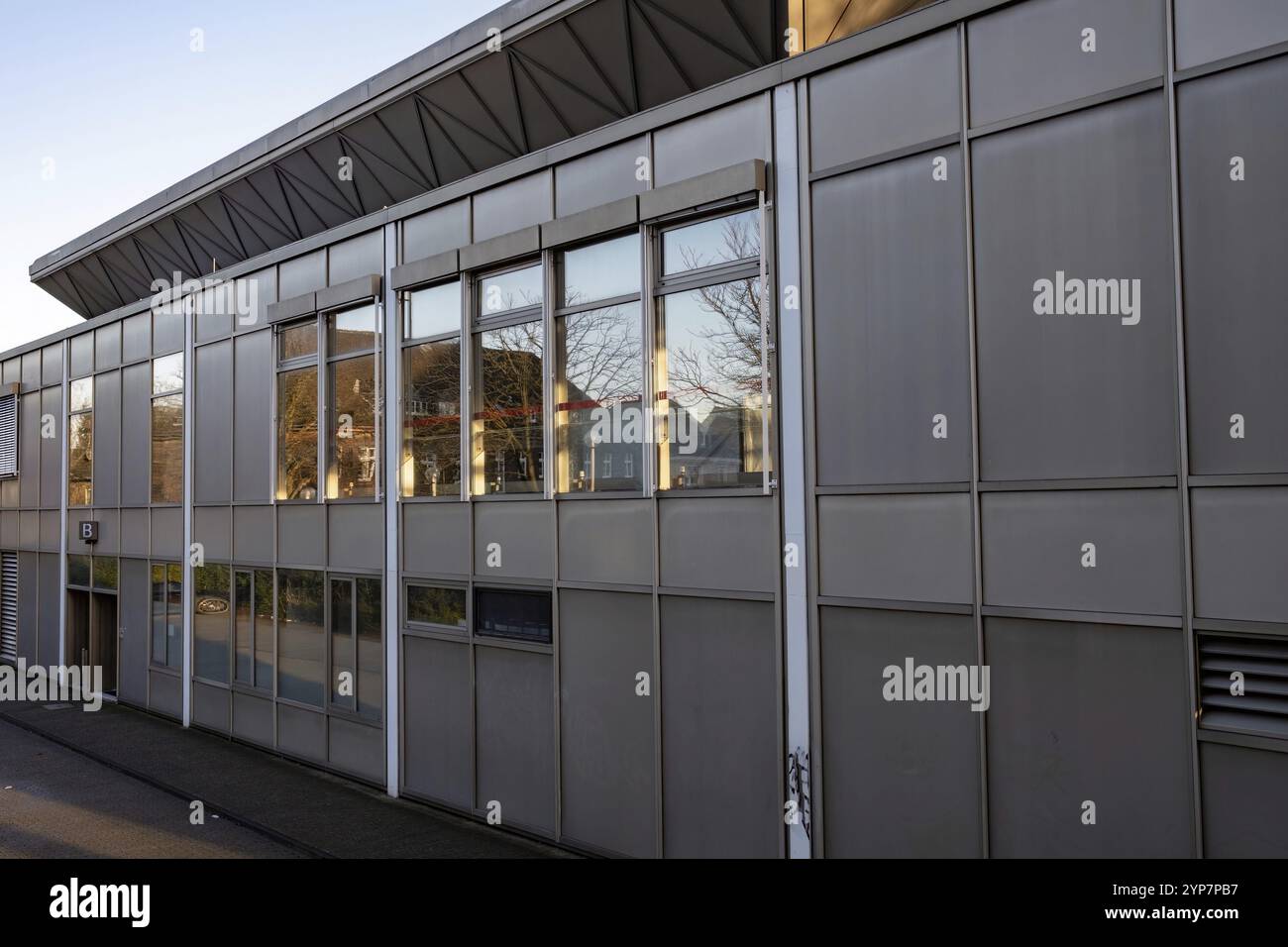 Modern architecture with metal paneled facade and reflective windows ...