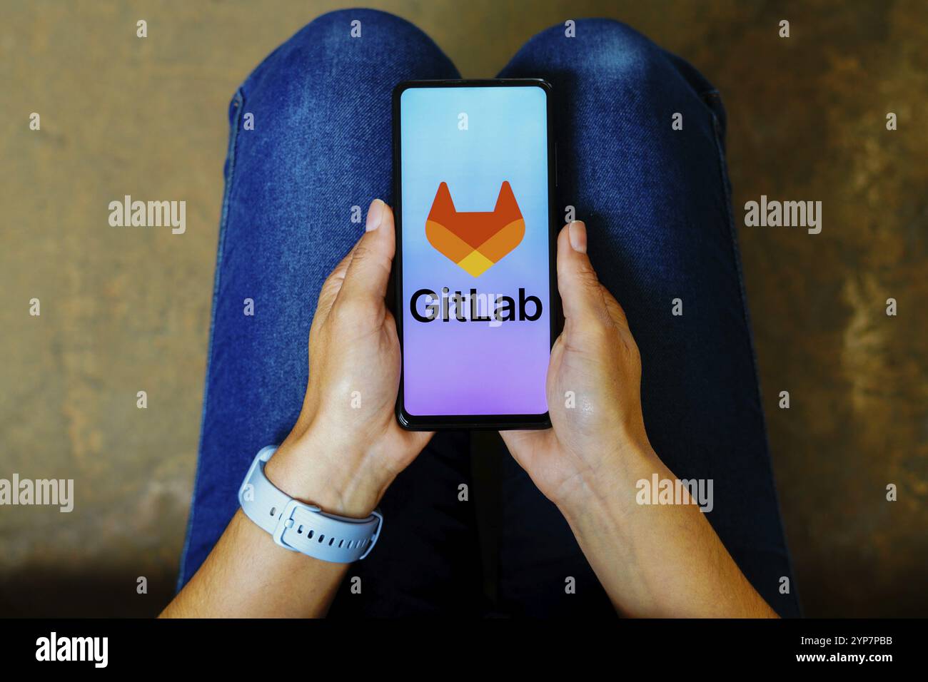 In this photo illustration, the GitLab logo is displayed on a ...