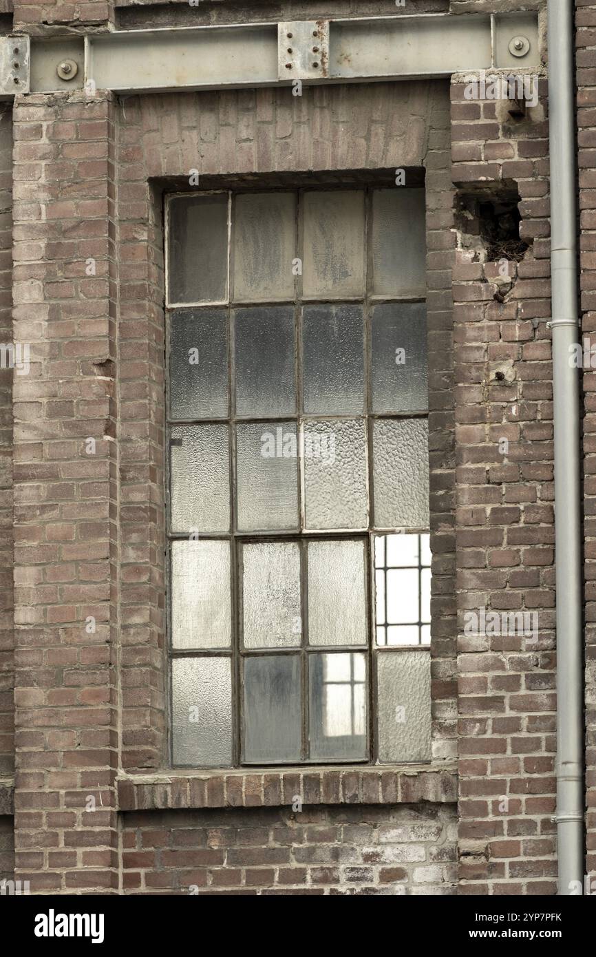 Details of an old industrial building, brick wall and windows, approx ...