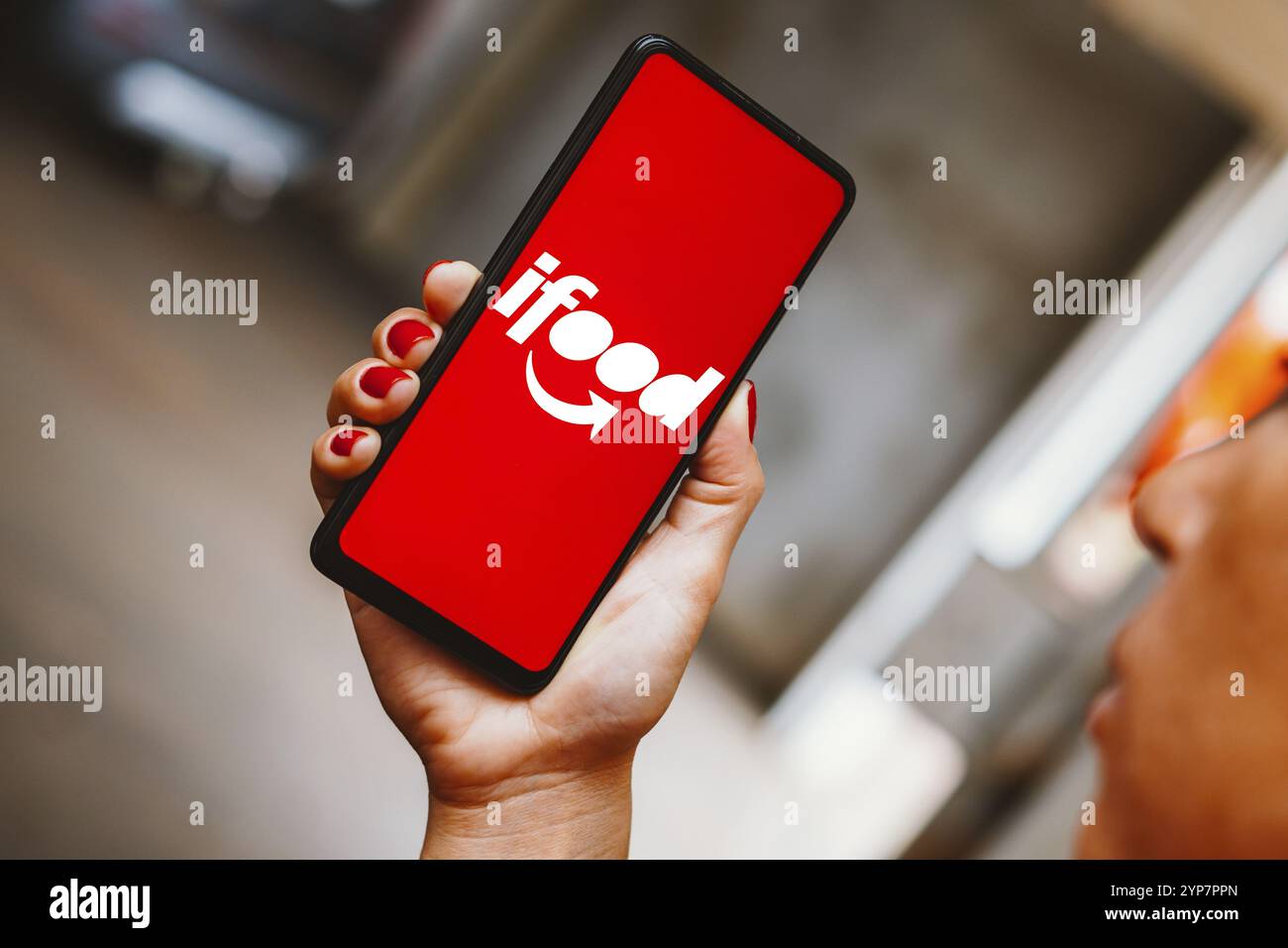 In this photo illustration, the iFood logo is displayed on a smartphone ...