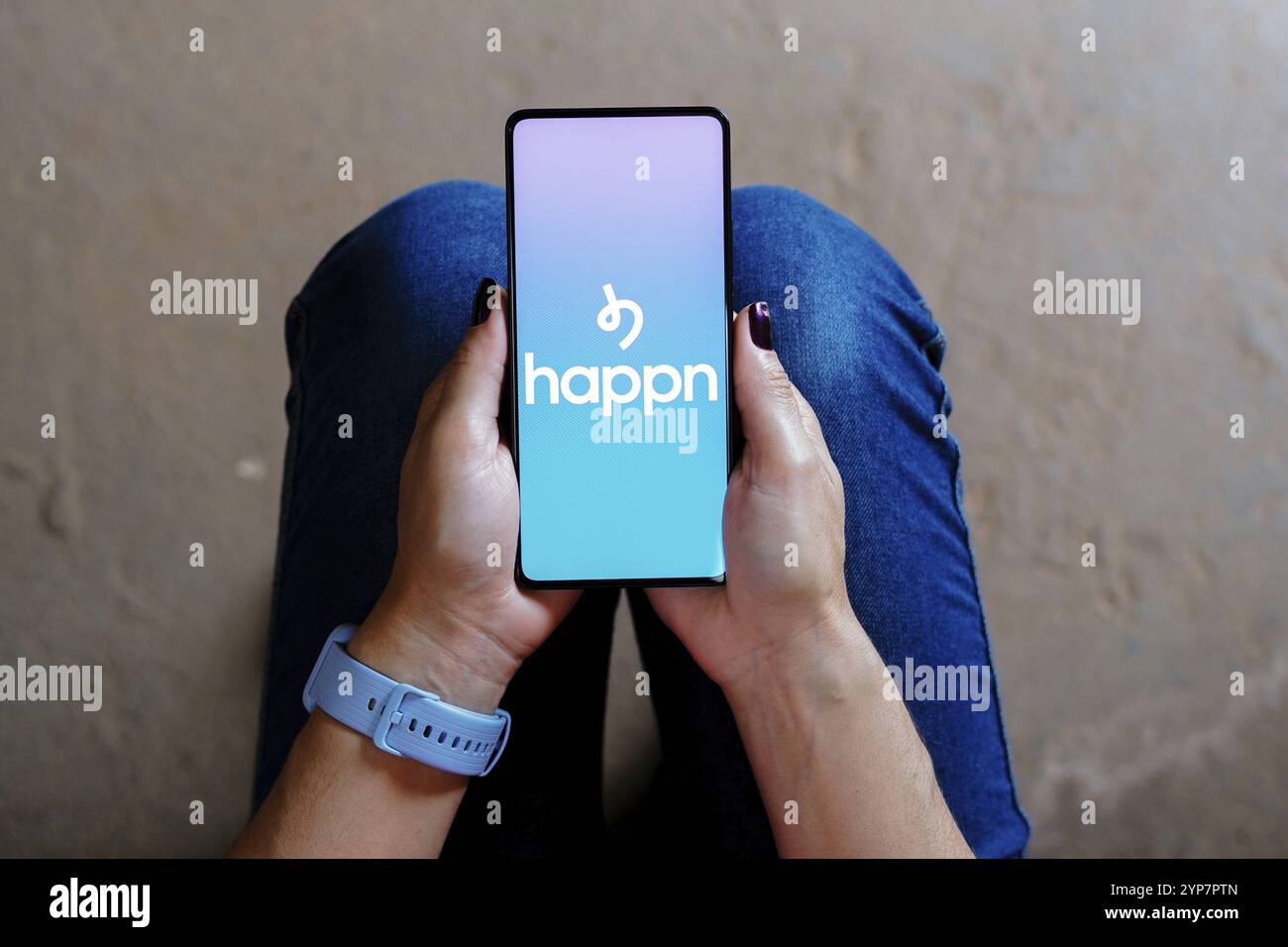 In this photo illustration, the Happn logo is displayed on a smartphone screen Stock Photo - Alamy