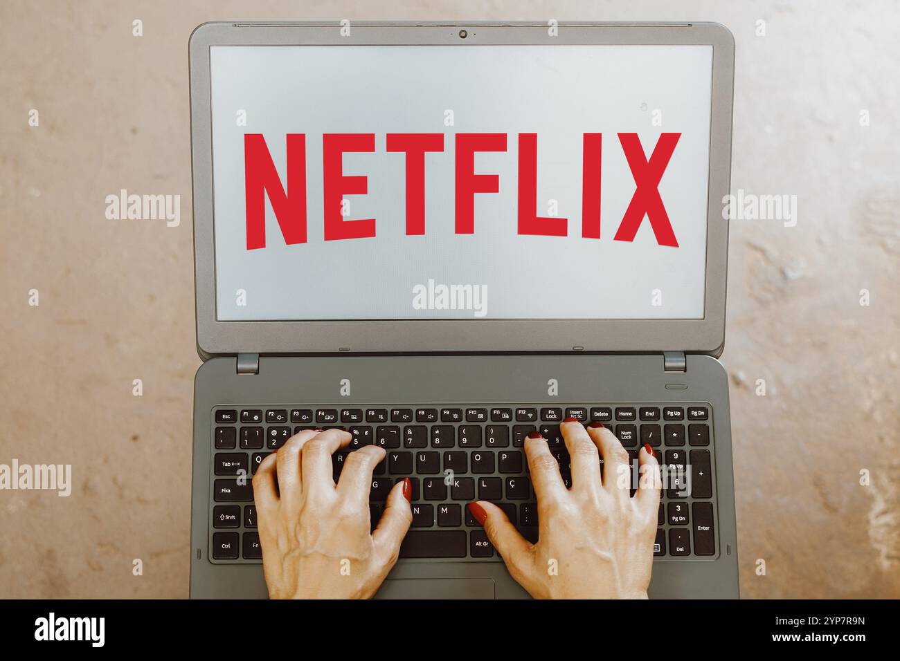 In this photo illustration, the Netflix logo is displayed on a notebook ...