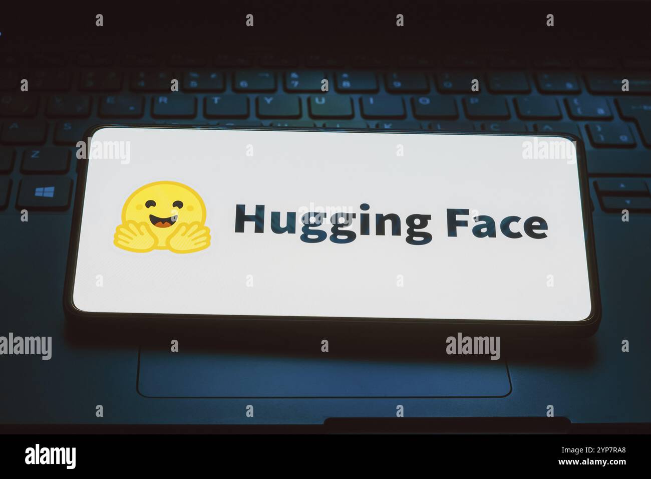 In this photo illustration, the Hugging Face logo is displayed on a ...