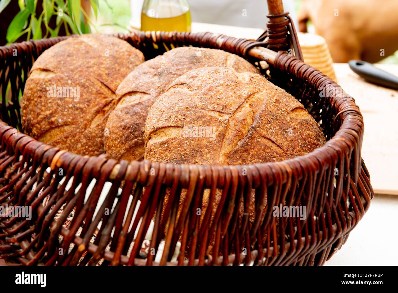three sourdough whole grain loaf of bread in the basket Stock Photo - Alamy