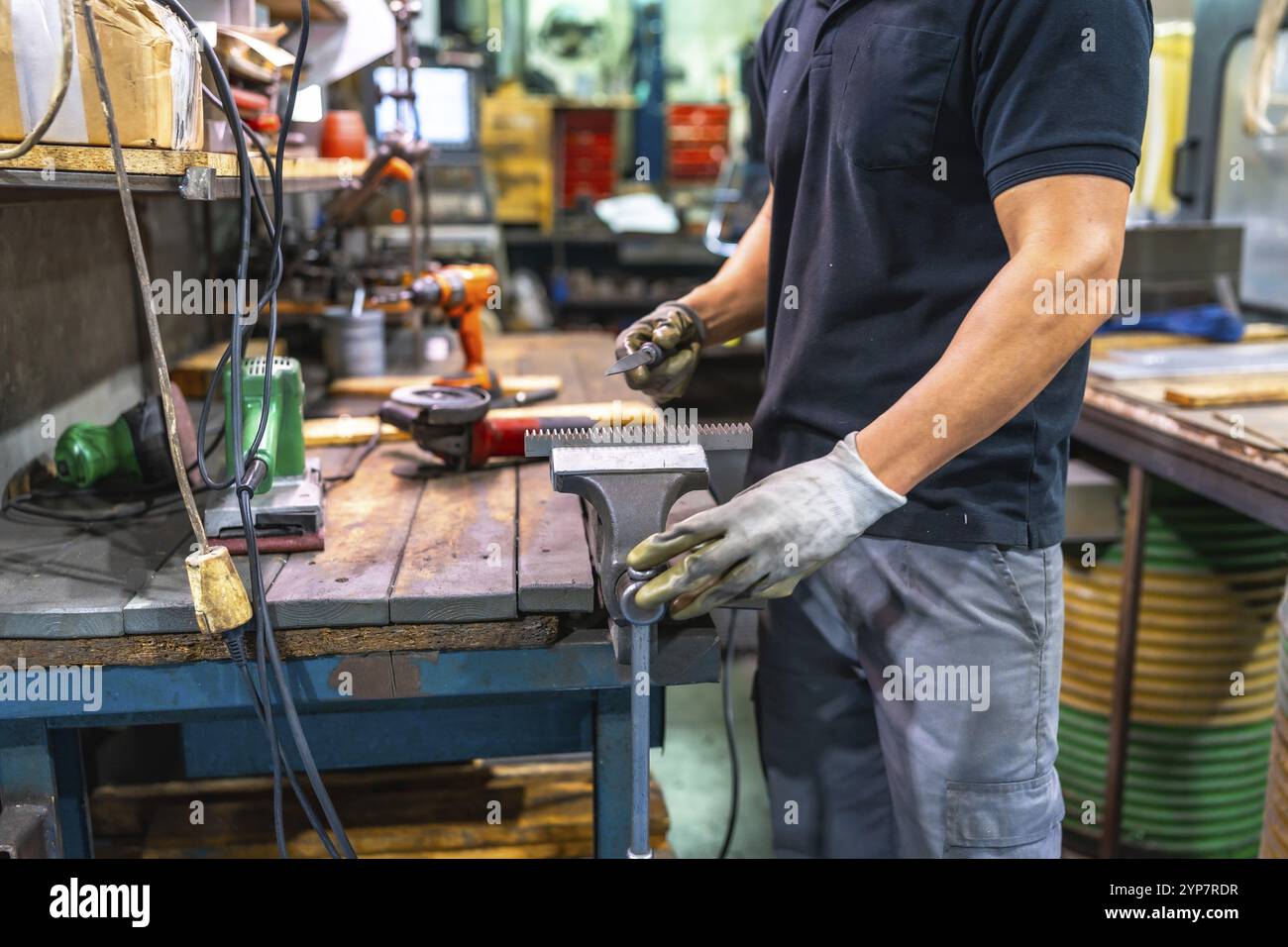 Part of an unrecognizable caucasian man using drill in a workshop ...