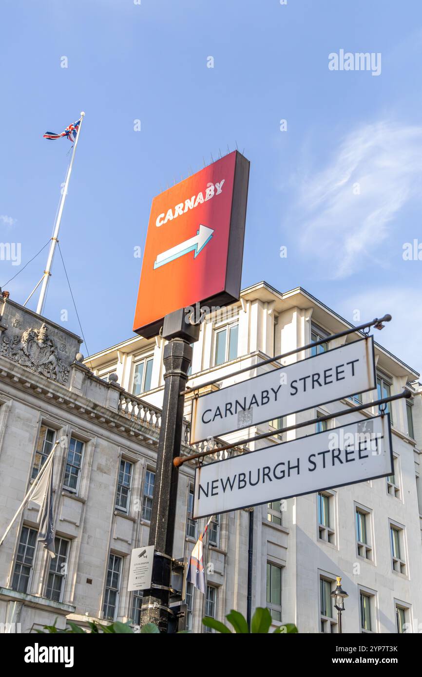 London, UK- September 19, 2024: Red Carnaby Arrow Sign and Union Jack ...