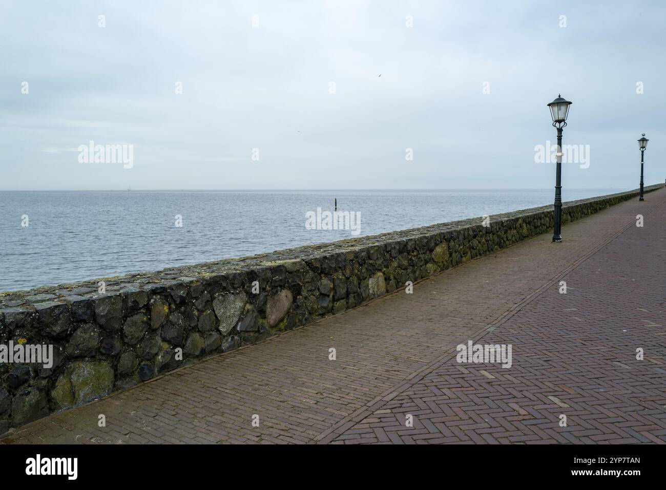 Paved street by the sea with lanterns Stock Photo - Alamy