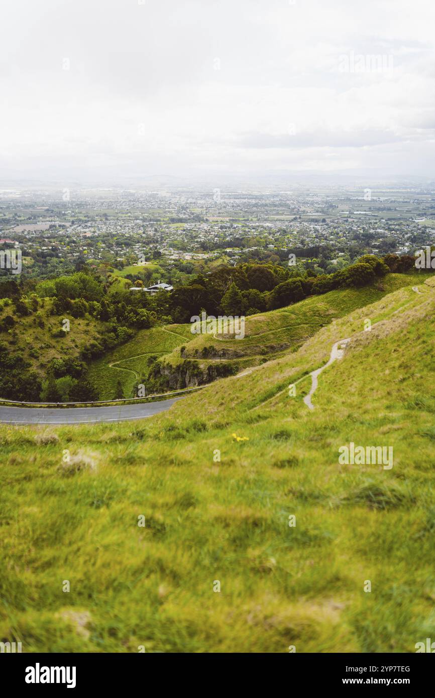 A view from a hill over a town in the distance, surrounded by green ...
