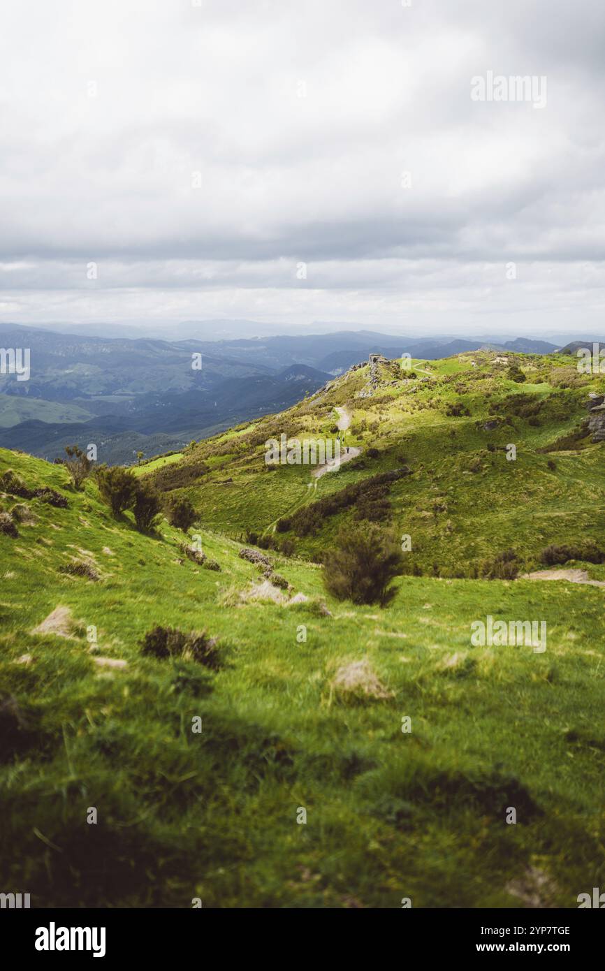 Green hills with a path leading into a wide valley, Bells Rock, Napier ...