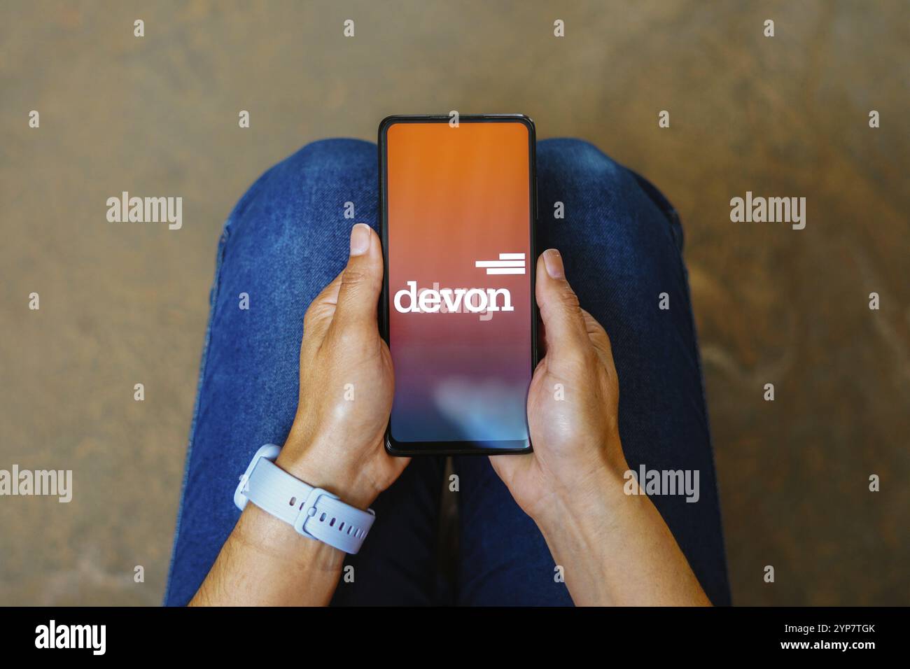 In this photo illustration, the Devon Energy logo is displayed on a smartphone screen Stock ...