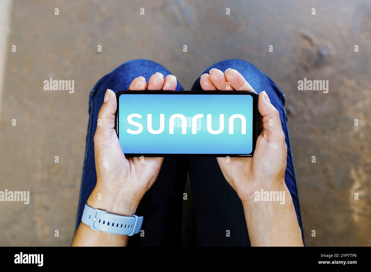 In this photo illustration, the Sunrun logo is displayed on a ...