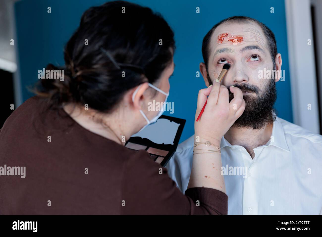 People behind the scenes getting prepared for horror movie shooting ...