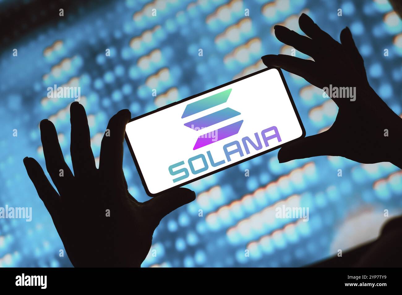 In this photo illustration, the Solana logo is displayed on a ...