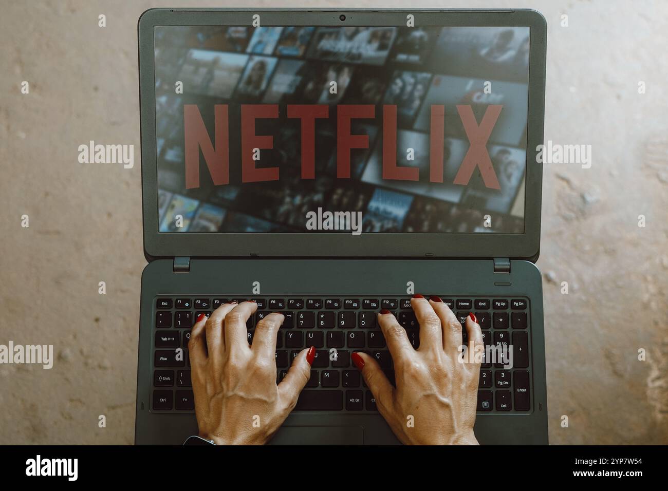 In this photo illustration, the Netflix logo is displayed on a notebook ...